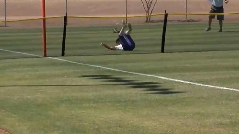 Outfielder goes over the wall to make a remarkable catch - ESPN Video