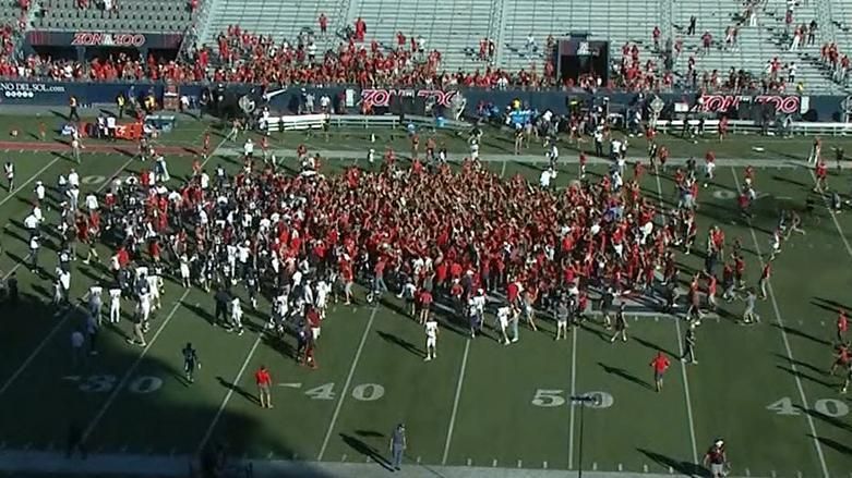 Students rush the field as the Wildcats end the nation's longest losing ...