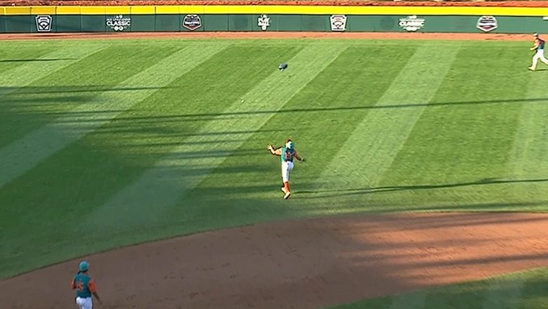 Little League shortstop throws his glove in attempt to stop the base ...