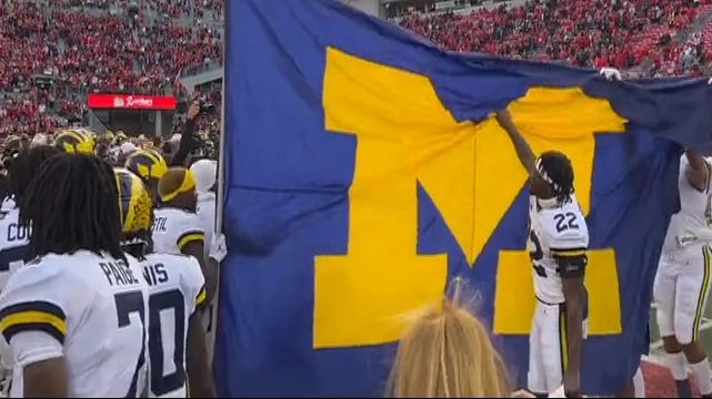 Michigan celebrates win over Ohio State by planting flag at midfield ...
