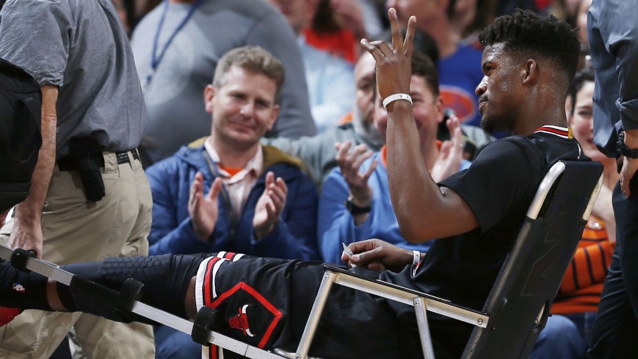 Jimmy Butler of Chicago Bulls leaves Denver Nuggets game with left knee ...